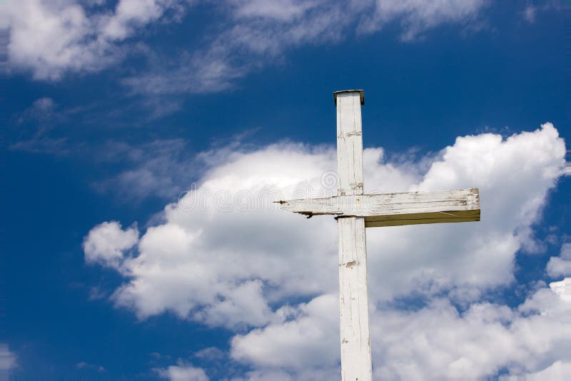 Cracked Wooden Cross Against a Blue Sky with Clouds. Stock Image ...