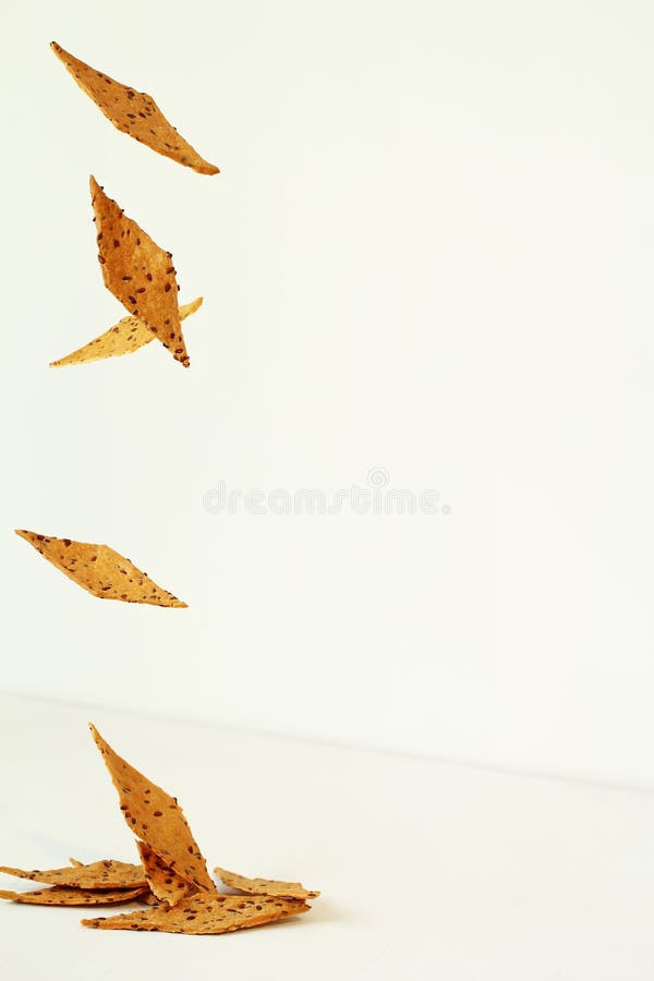 Cracker with Flax Seeds Falling Down Like Autumn Leaves on White ...
