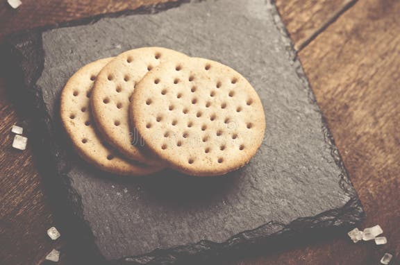Crackers Stack Together on Black Stone, Coarse Sugar on Wooden B Stock ...