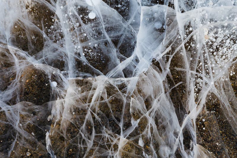 Cracks on Surface of Lake Create Ice Patterns. Methane Bubbles in ...