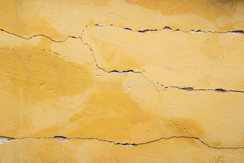 Cracks in the yellow wall stock image. Image of building - 137194251