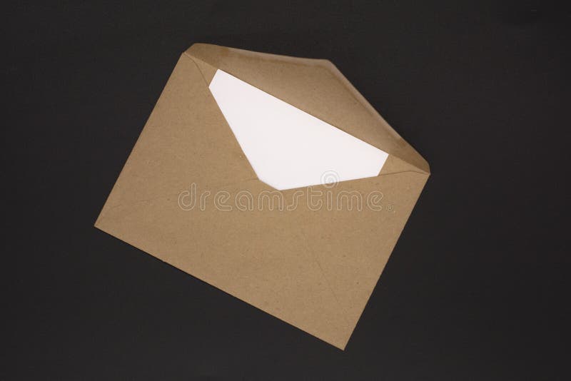 Craft Envelope with a Blank Sheet of Paper Inside on a Black Background ...