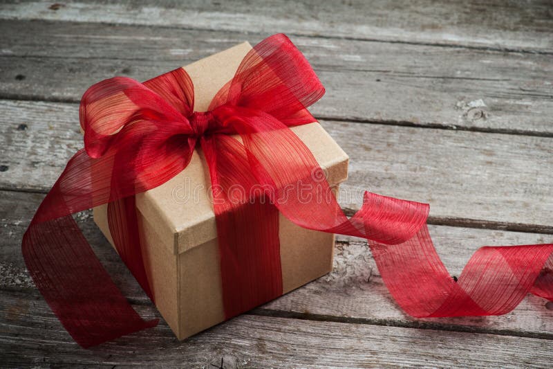 Craft Paper Gift Box with Red Bow on Wooden Table Stock Photo - Image ...