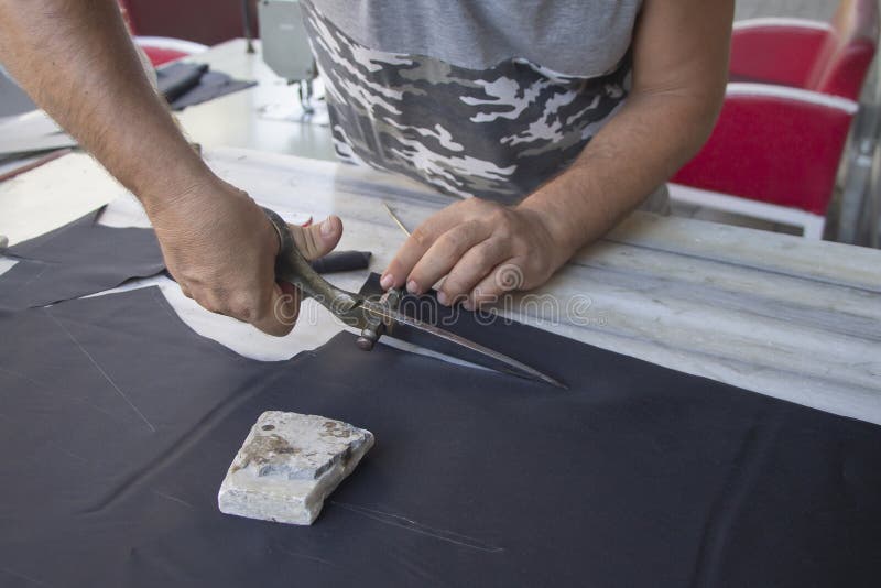 Craft Workshop on Sewing Leather Jackets. the Master Cuts the Skin ...
