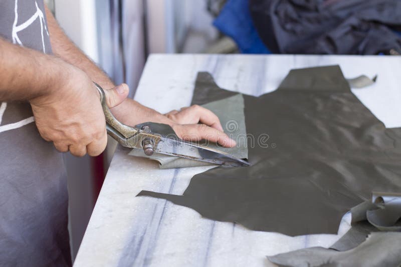 Craft Workshop on Sewing Leather Jackets. the Master Cuts the Skin ...