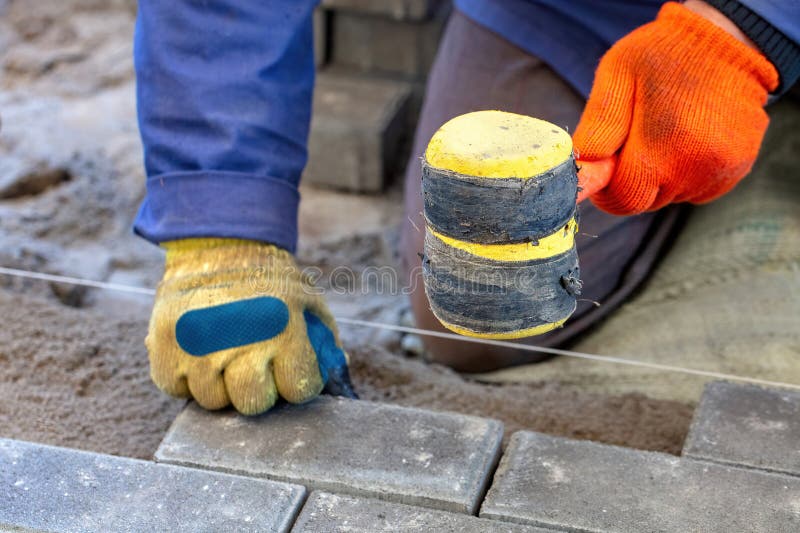 Crafting a Pathway with Precision and Care in a Sunlit Construction ...