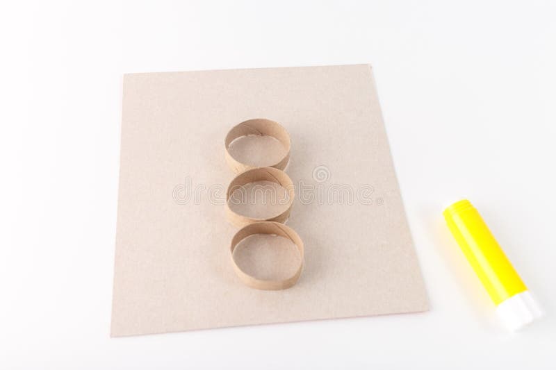 Crafting in Progress, a Piece of Cardboard with Three Cardboard Rings ...