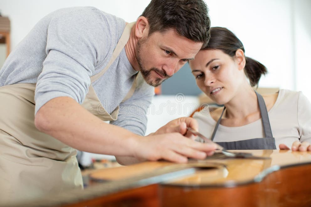 Craftsman with Apprentice Repairing Guitar Stock Photo - Image of handmade, maintenance: 332667954