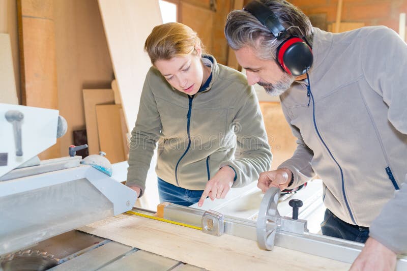Craftsman and Carpenter Working As Team Cutting Wood Stock Photo ...
