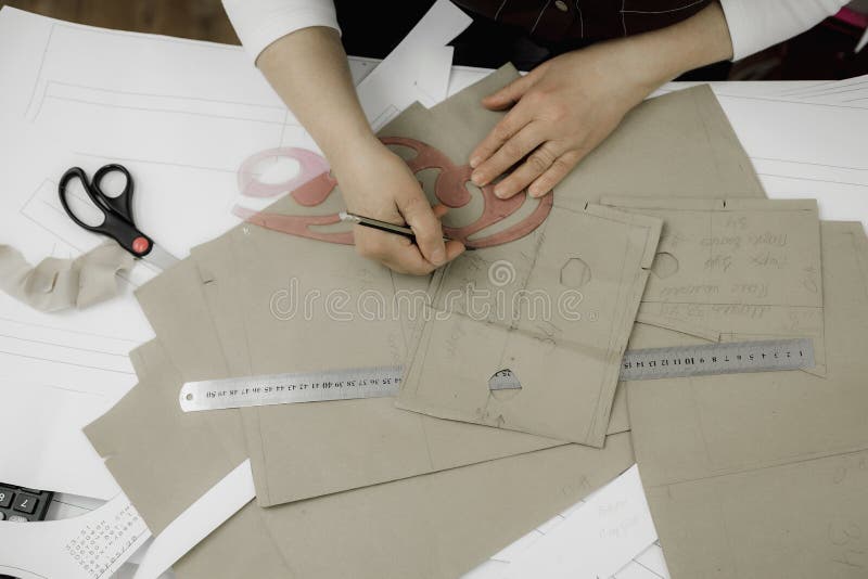The Craftsman Draws Cutting Patterns for Sewing Clothes Stock Image ...