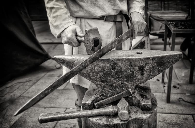 Craftsman Forging a Sword with a Hammer Blow Stock Image - Image of ...