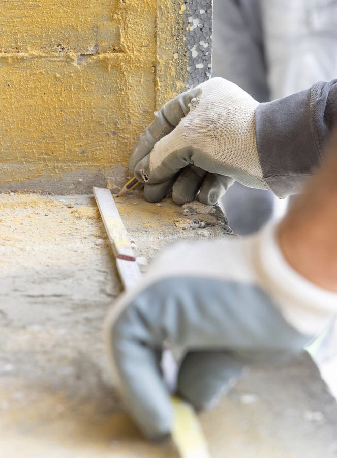 Craftsman in Gloves Measuring a Dirty Surface with Folding Ruler ...