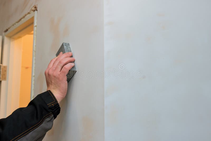 Closeup of a Craftsman Grinding a Wall with Sandpaper. Stock Photo ...