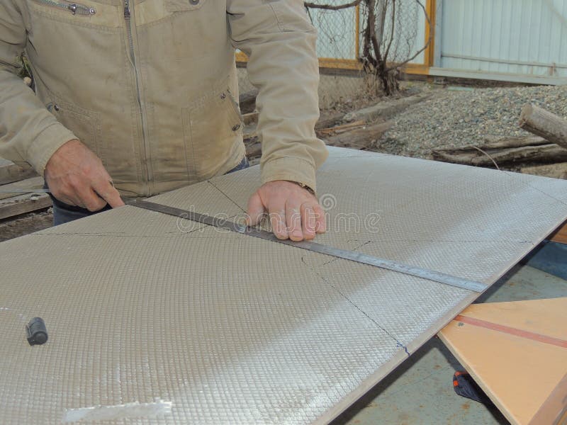 A Craftsman Measures the Width of a Large Tile from the Back Side Stock ...