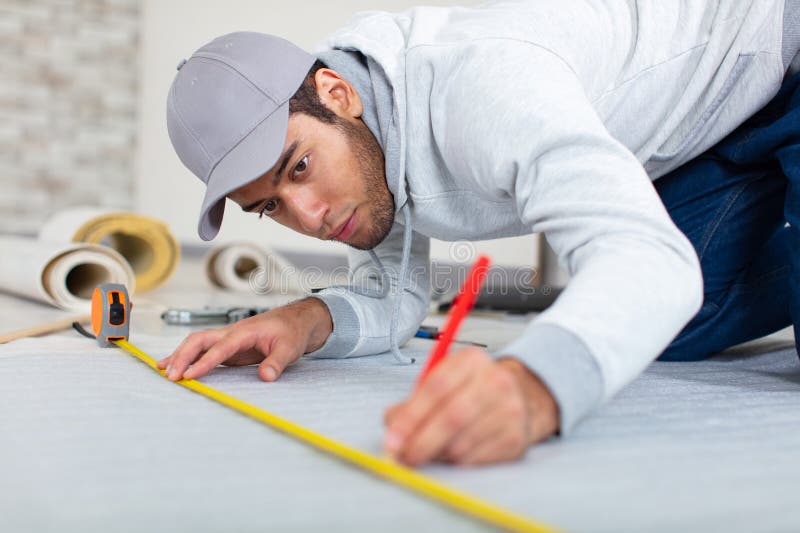 Craftsman Measuring Position on Floor with Ruler and Pencil Stock Photo ...