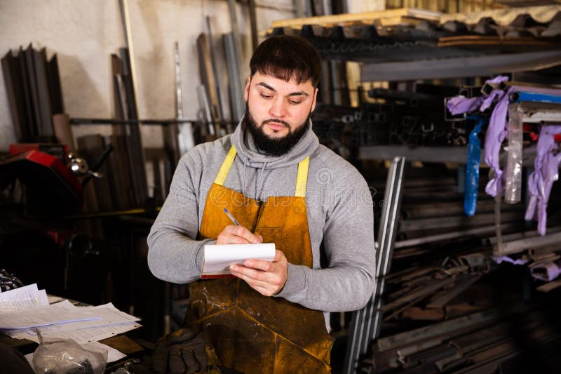 Craftsman of Metalworking Shop Writing in Notebook Stock Photo - Image ...