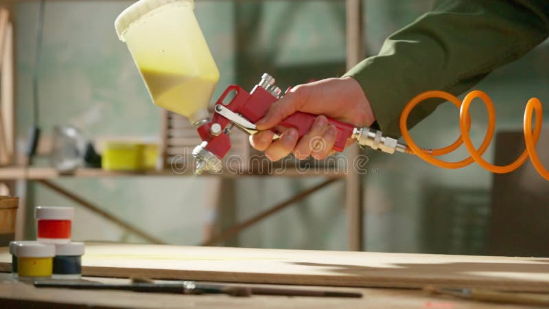 A Craftsman Paints a Wooden Board with a Red Paint Gun. Stock Footage ... A Craftsman Paints a Wooden Board with a Red Paint Gun. Stock Footage ...