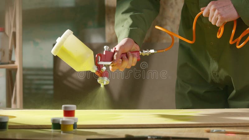 A Craftsman Paints a Wooden Board with a Red Paint Gun. Stock Footage ... A Craftsman Paints a Wooden Board with a Red Paint Gun. Stock Footage ...