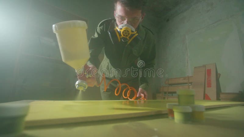 A Craftsman Paints a Wooden Board with a Red Paint Gun. Stock Footage ... A Craftsman Paints a Wooden Board with a Red Paint Gun. Stock Footage ...