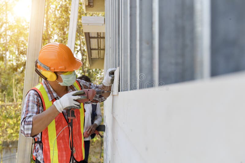 Construction Worker with Panel,Construction Worker during Wall Stock ...