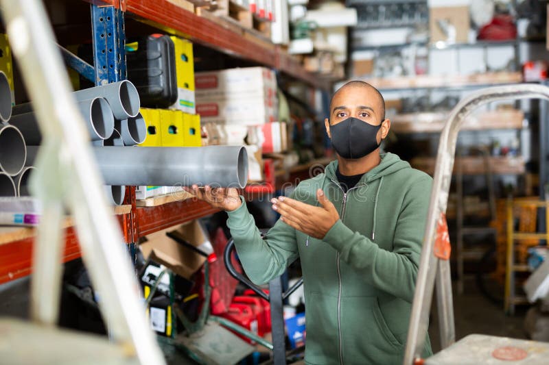 Craftsman in Protective Mask Selects Plastic Plumbing Pipes in Hardware ...