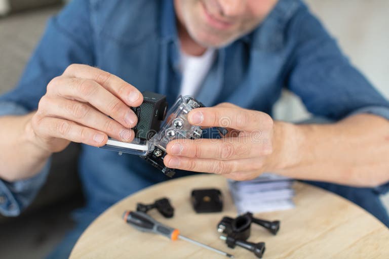 Craftsman Repairs Video Camera with Screwdriver Stock Photo - Image of ...