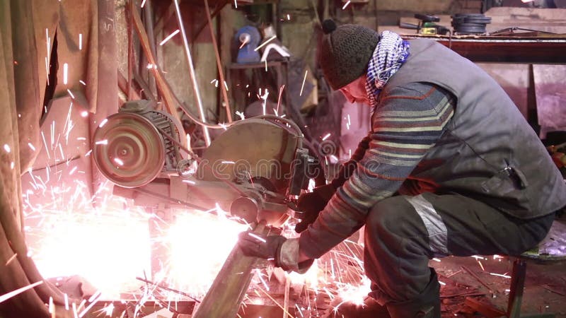 Craftsman Sawing Metal. a Man Using Polishing Machine for Grinding ...
