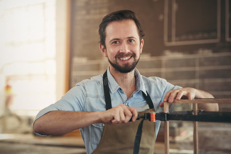 Craftsman Smiling with the Project he is Busy Making Stock Photo ...