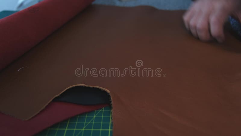 Craftsman Unrolling and Arranging Leather and Fabric Pieces Stock Video ...