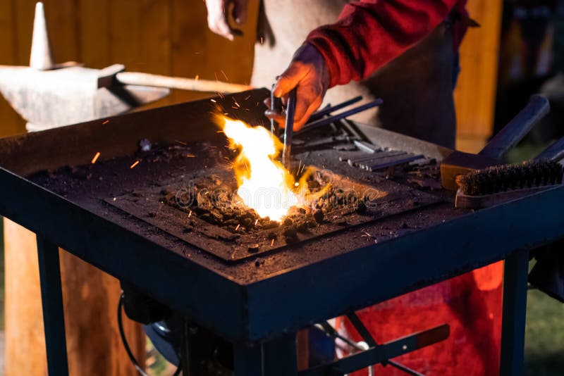 A Craftsman Working with Fire and a Hammer on a Glowing Iron. Middle ...