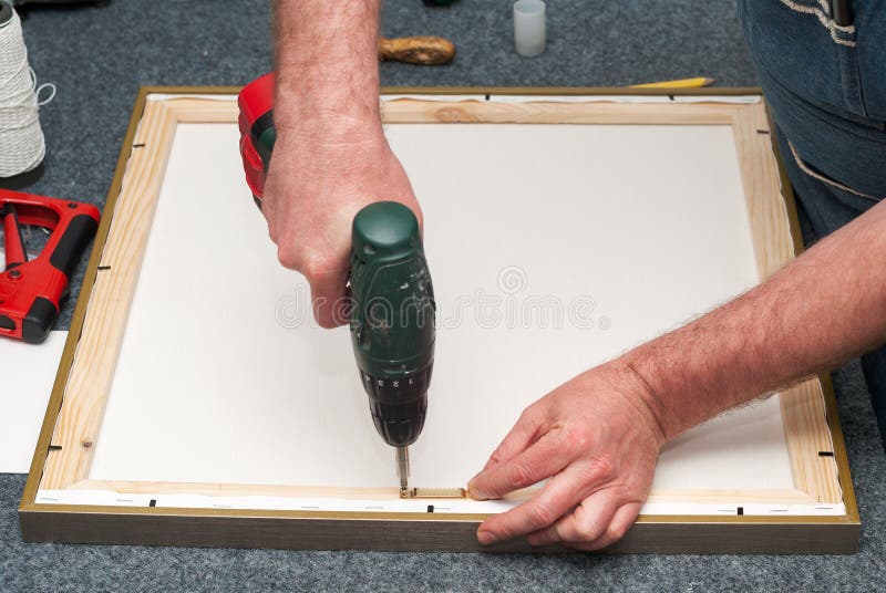 Professional Framer Hand Holding Frame, Cutting it with Machine Stock ...