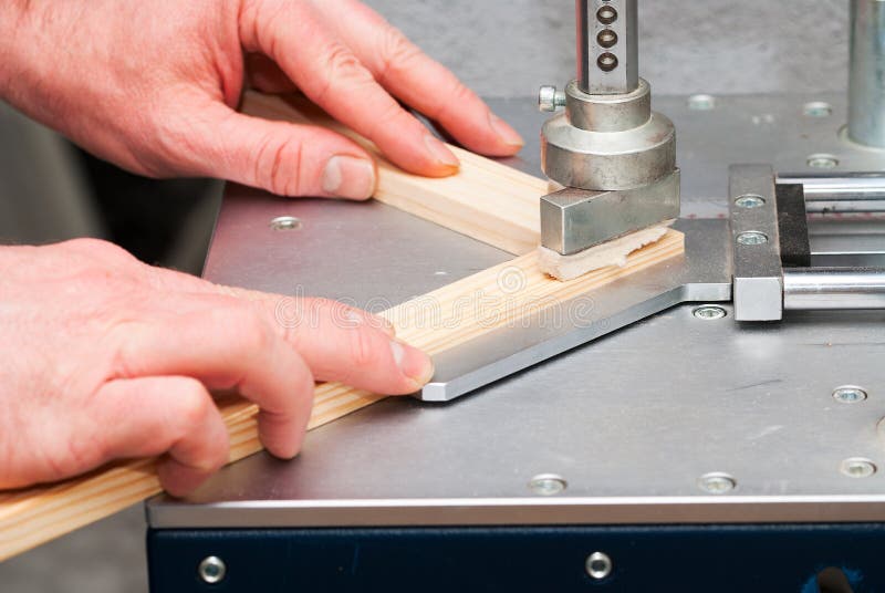 Professional Framer Hand Holding Frame, Cutting it with Machine Stock ...