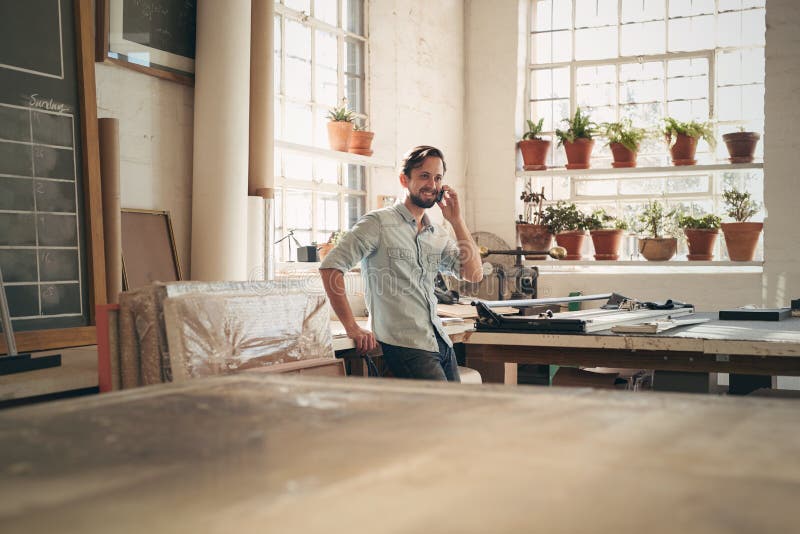 Craftsperson Talking on Phone in Workshop Studio Stock Image - Image of ...