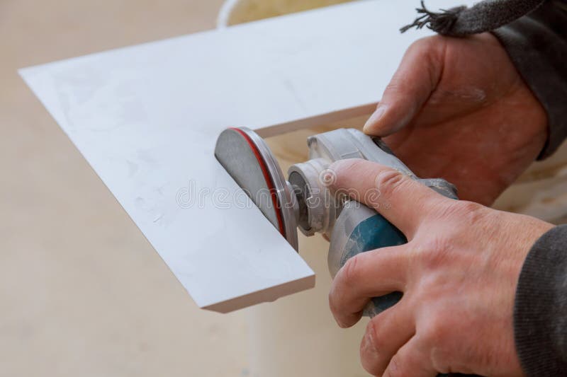Craftsperson Using Sander on Ceramic Tile in Workshop during Create ...