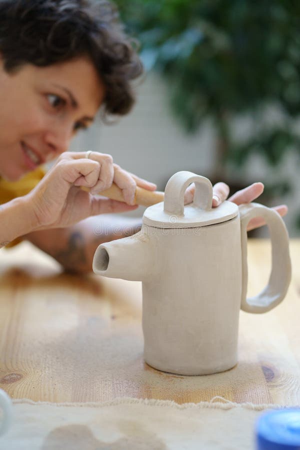 Craftswoman at Work Scraping and Shaping Clay Pottery Jug with ...