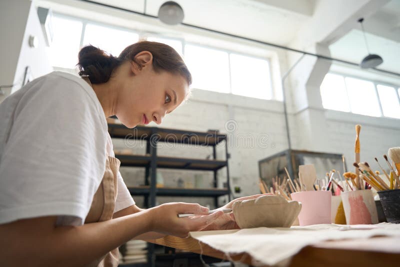 Craftswoman Works with a Special Stack on a Clay Plate Stock Image ...