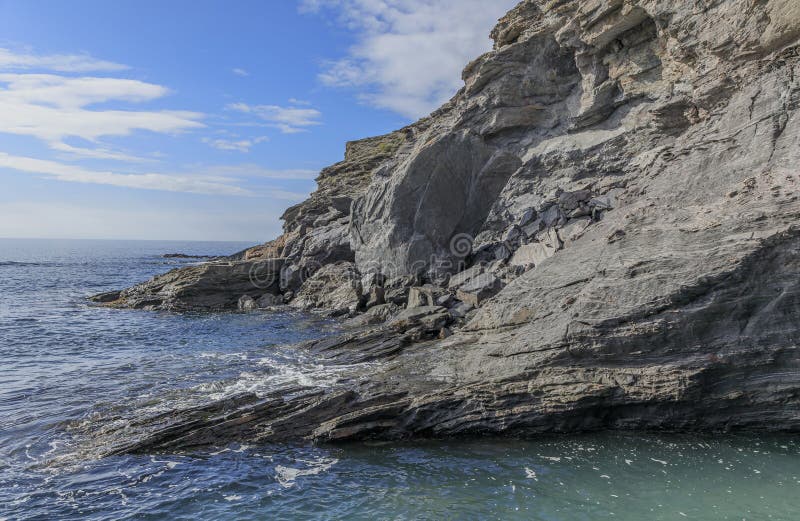 Craggy Cliffs Going Down into a Calm Sea Stock Photo - Image of ...