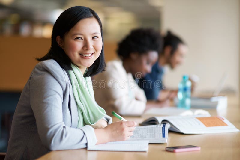 Cramming Some Last Minute Knowledge. a Young Woman Studying in the ...