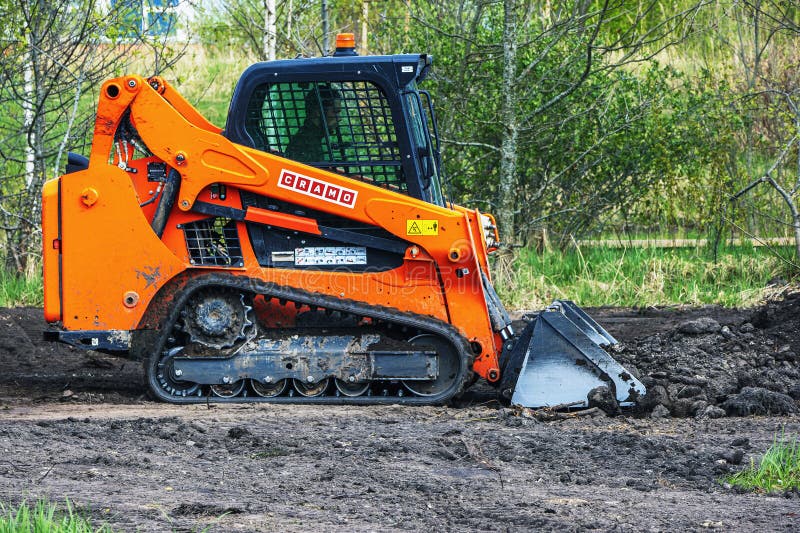 Cramo Mini Loader, Bulldozer Leveling the Ground in the Park Editorial ...