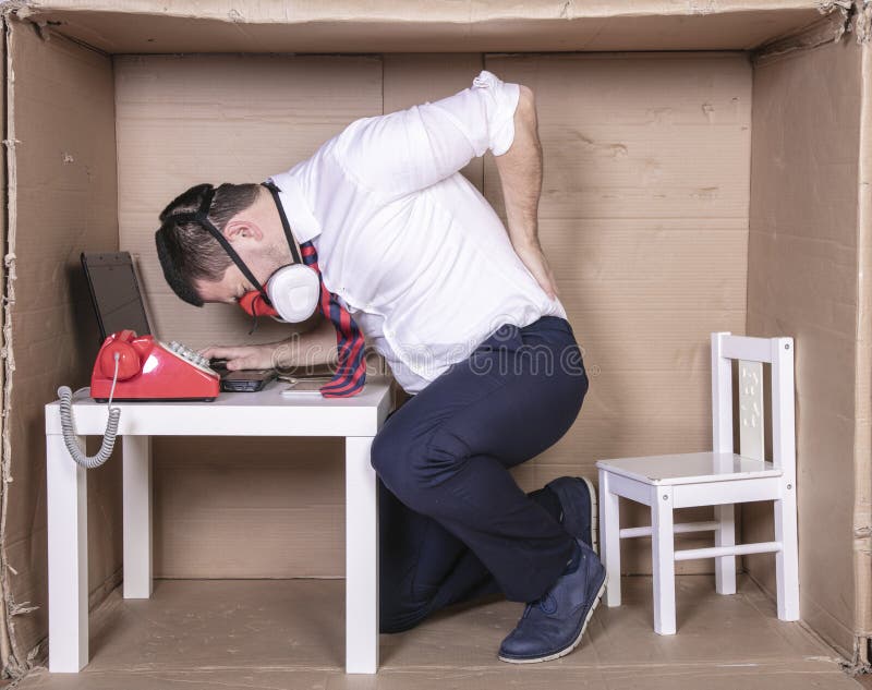 Businessman in a Cramped Cardboard Office Trying To Focus on His Work ...
