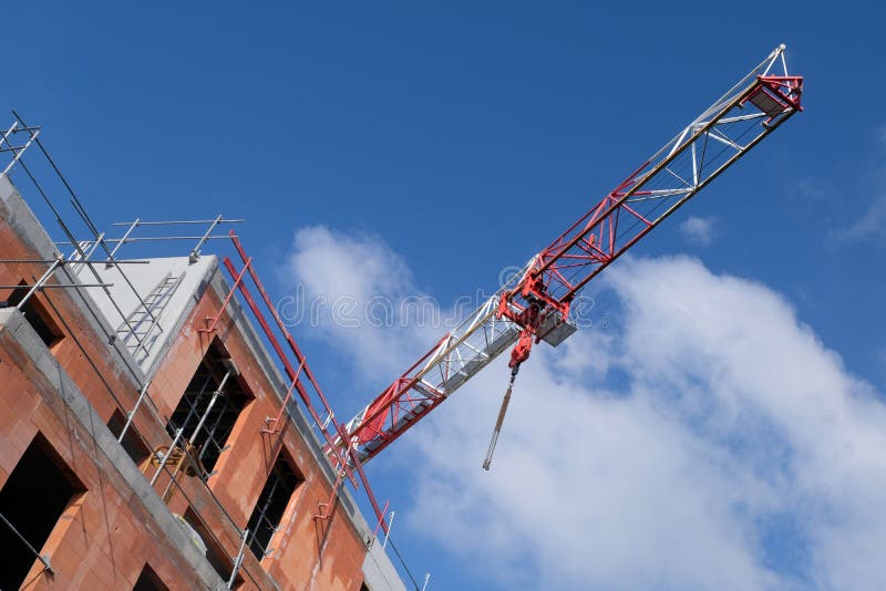 Crane Above a Building Under Construction with Terracotta Insulating ...