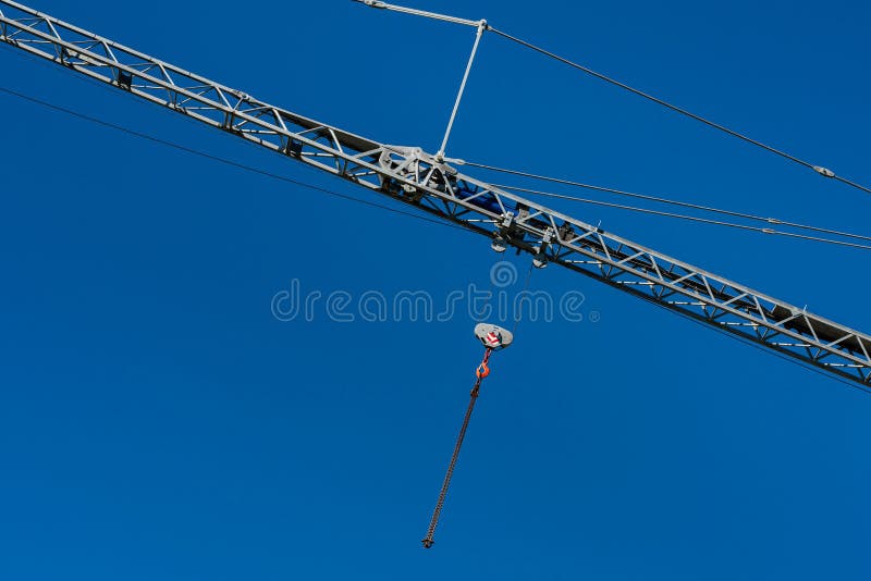 Crane Boom with a Hook Against the Blue Sky Stock Photo - Image of hook ...