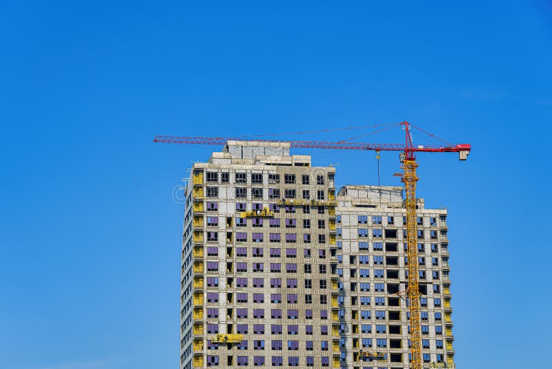A Crane Building a Skyscraper Against a Blue Sky. Stock Image - Image ...
