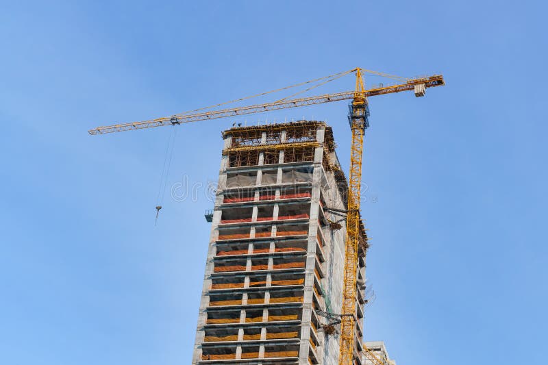 A Crane Building a Skyscraper Against a Blue Sky. Stock Photo - Image ...