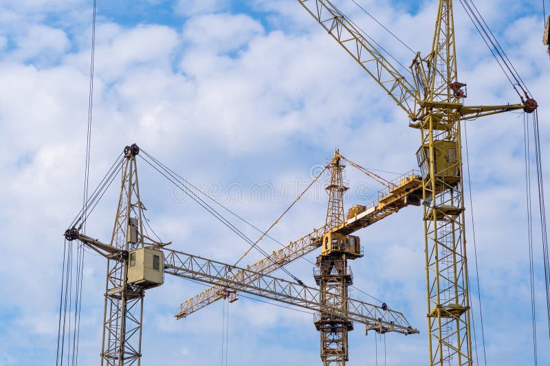 Crane and a Building Under Construction Against a Blue Sky Background ...