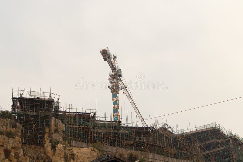 Crane and Building Under Construction Against Sky is Covered with White ...