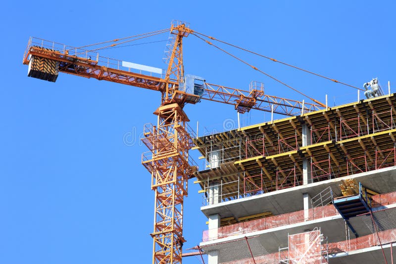 High Rise Building Construction Site with Crane on Blue Sky Background ...