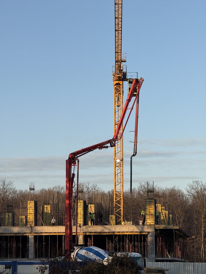 Crane and concrete pump stock photo. Image of building - 355786108