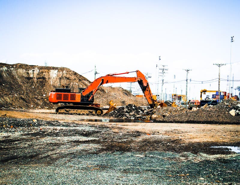 Crane dig into the ground stock photo. Image of tractor - 91539644