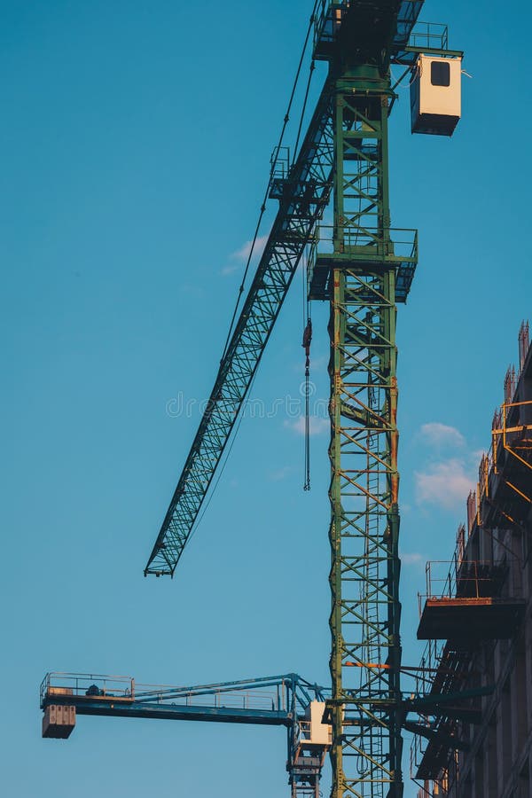 Crane on Construction Site - Building. Tower Crane Over Blue Sky ...